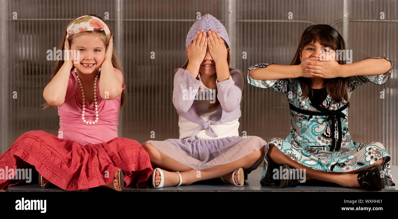 Three kids in the classic denial of evil pose Stock Photo - Alamy