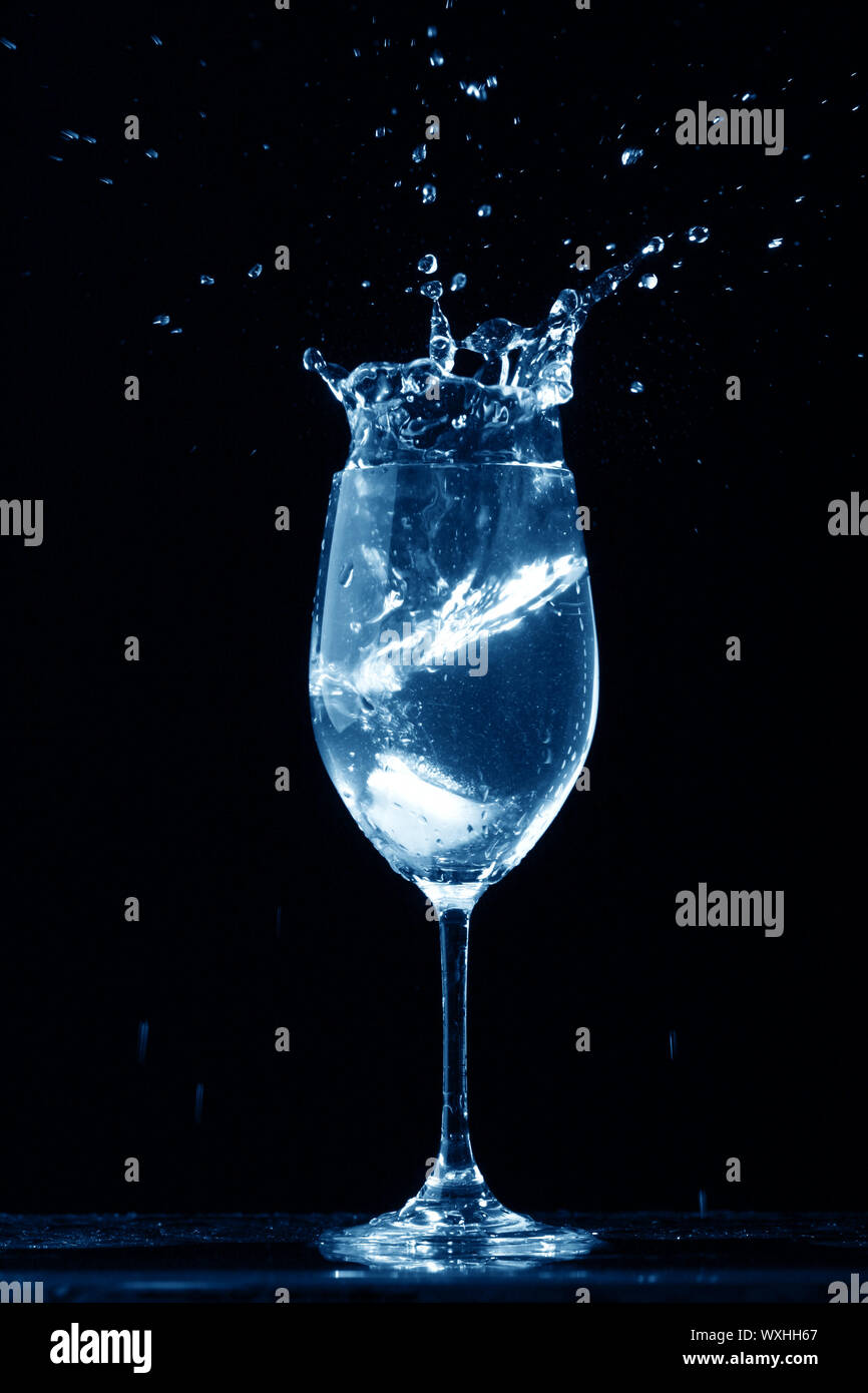 alcohol splash on black background Stock Photo - Alamy