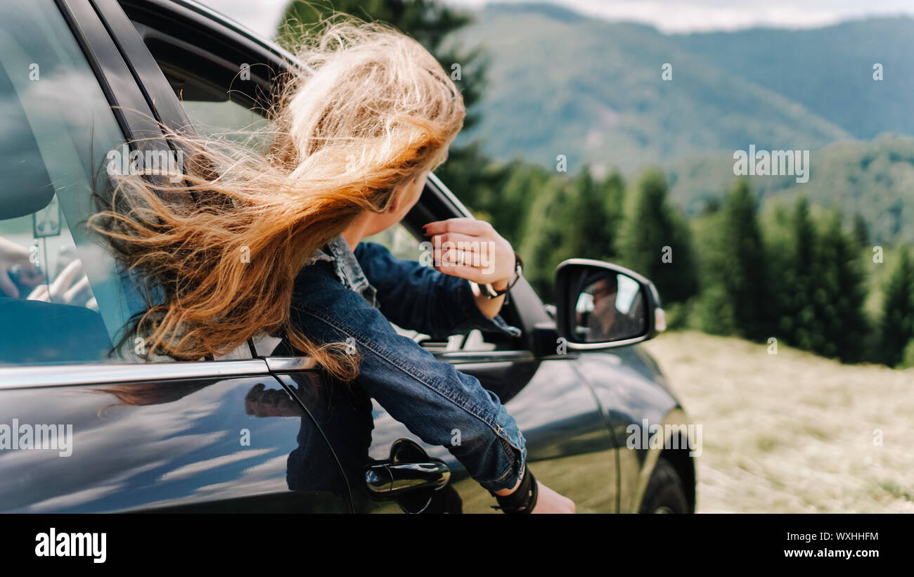 Happy woman travels by car in the mountains. Summer vacation concept ...