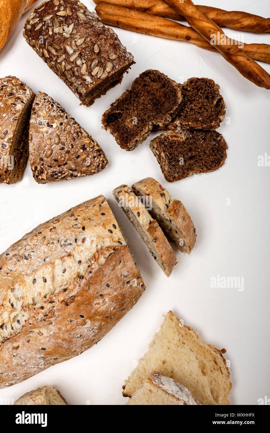 Different types of bread on a white background. Top view Stock Photo ...