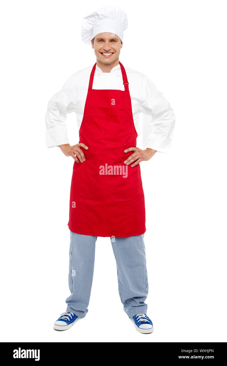 Full length portrait of relaxed chef standing with hands on his waist ...