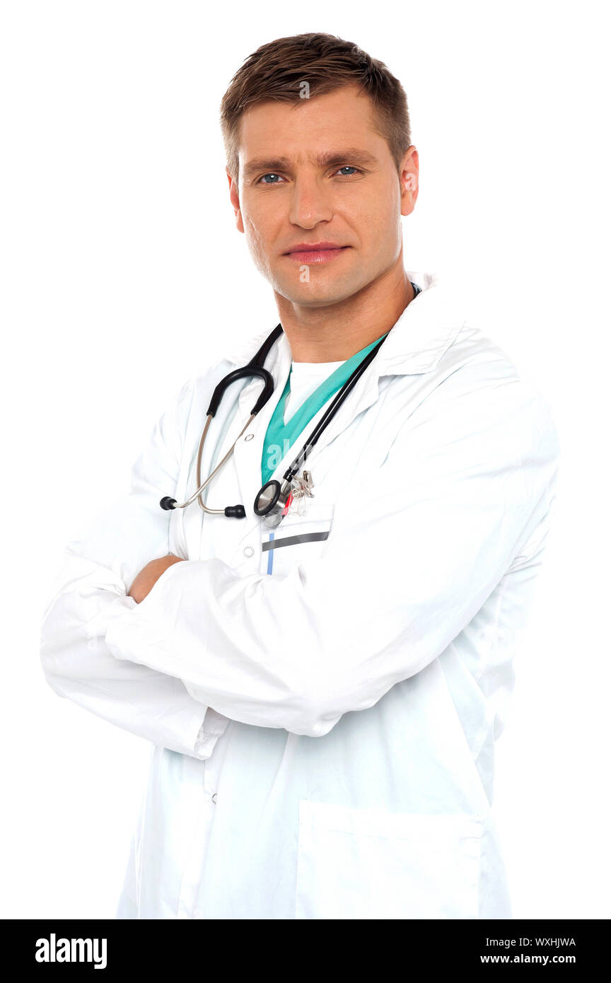 Handsome young doctor posing with crossed arms against white background Stock Photo - Alamy