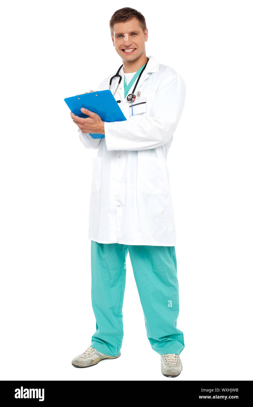 Full length of portrait smiling doctor with clipboard standing against ...