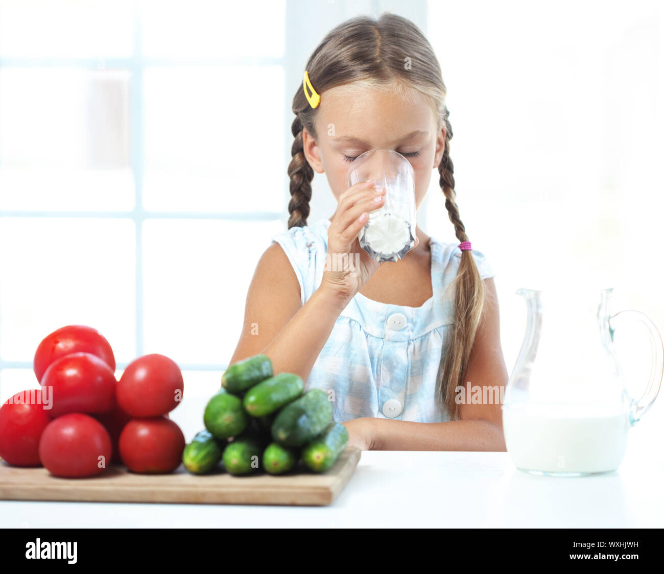 Child drinking milk in the kitchen at home Stock Photo - Alamy