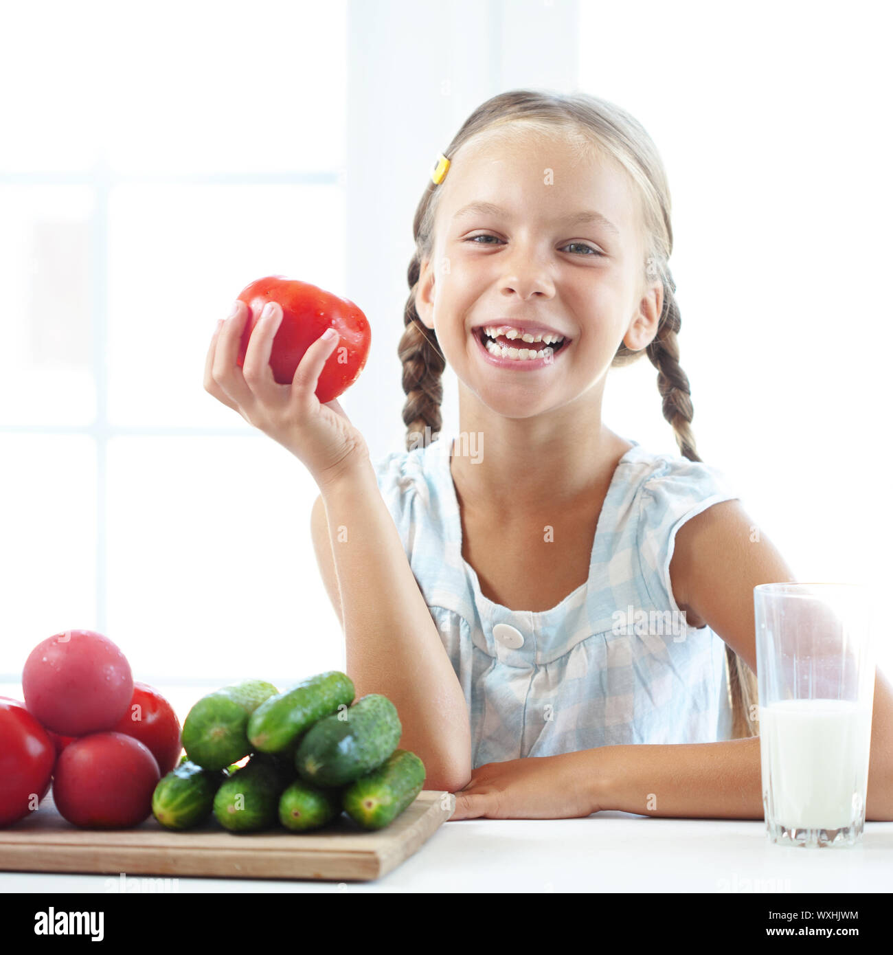 Child eating vegetables in the kitchen at home Stock Photo - Alamy
