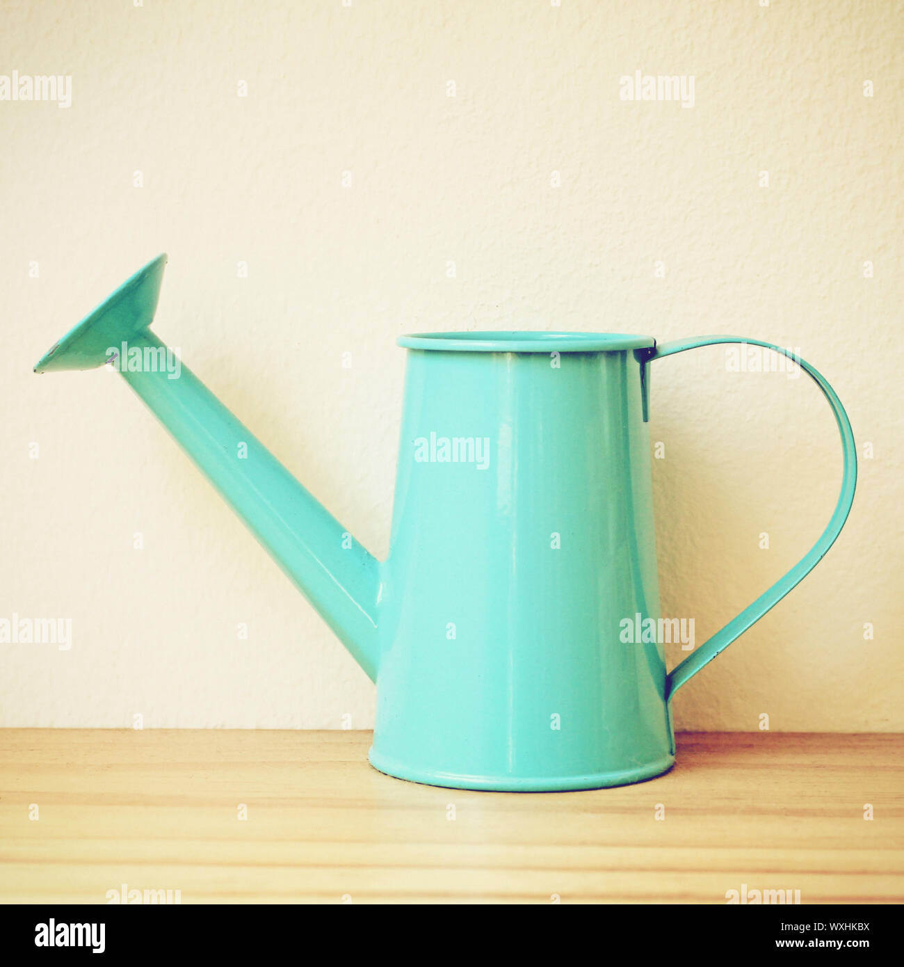 Blue retro watering can with filter effect Stock Photo - Alamy