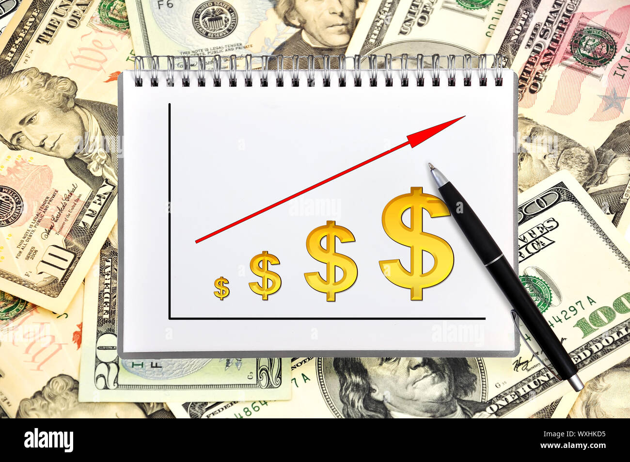 notebook with chart on a money background Stock Photo - Alamy