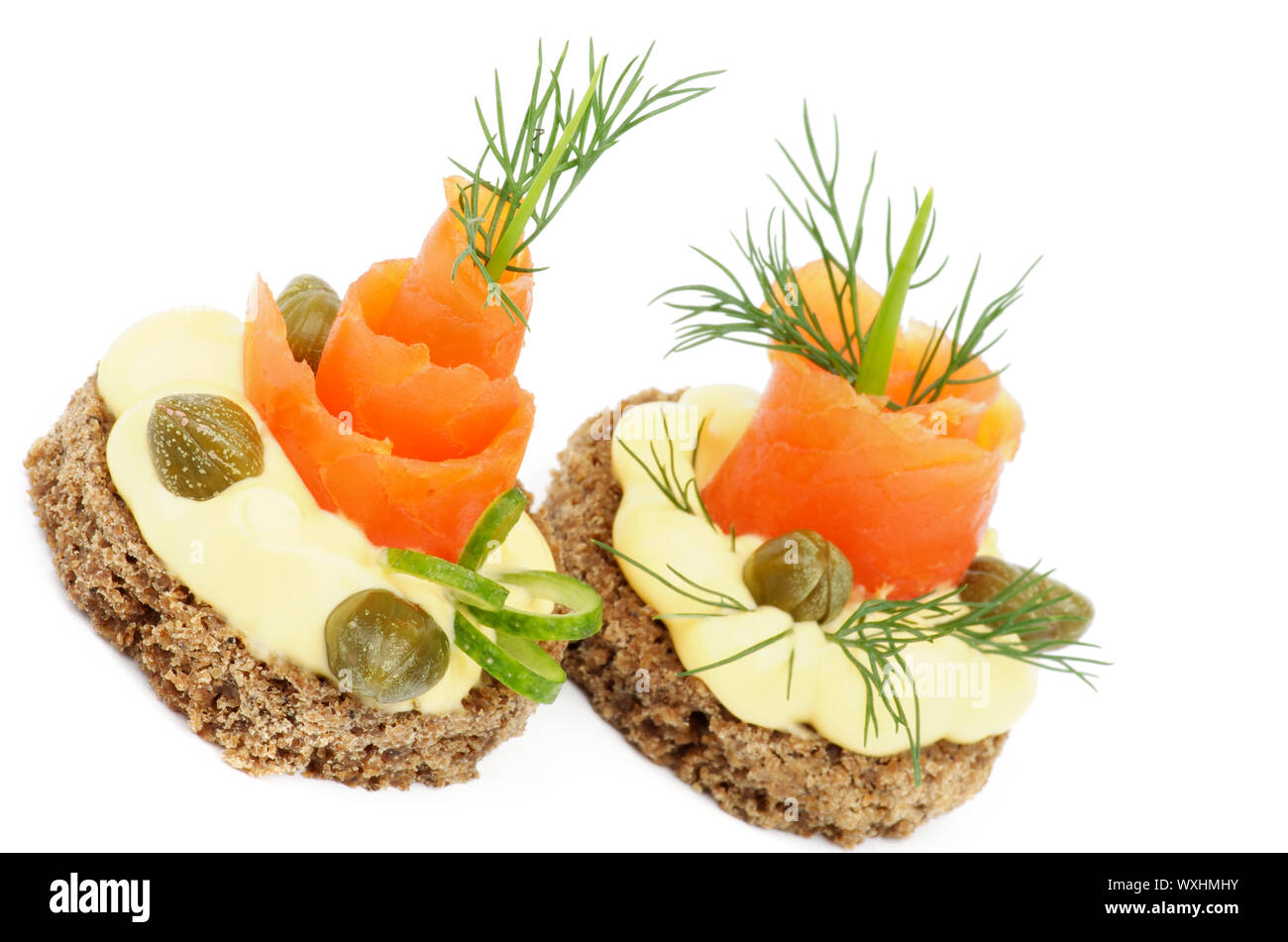 Snacks with Smoked Salmon, Greens, Cheese Cream and Capers isolated on ...