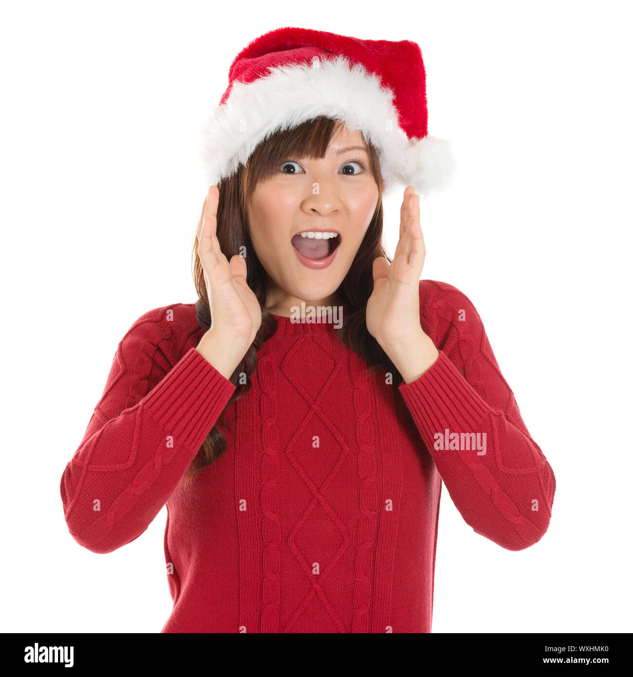 Shocked Asian Santa woman shouting isolated over white background ...