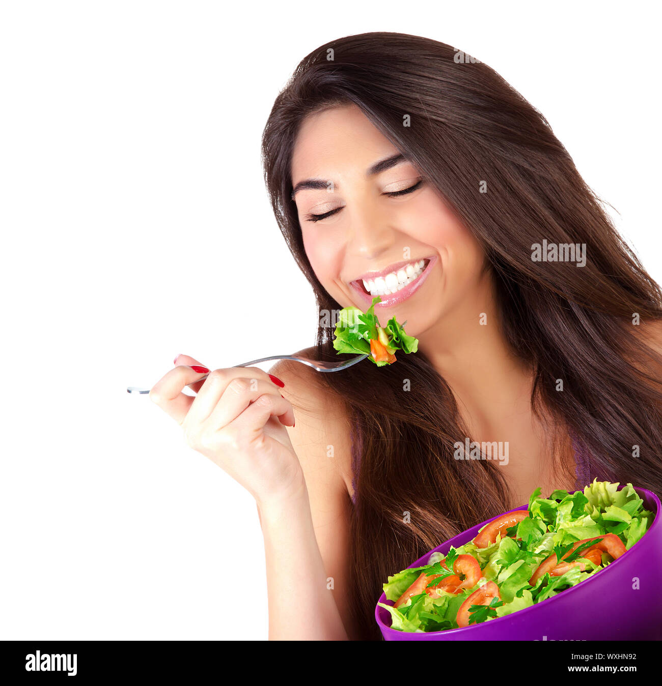 Cute girl eating salad Stock Photo - Alamy