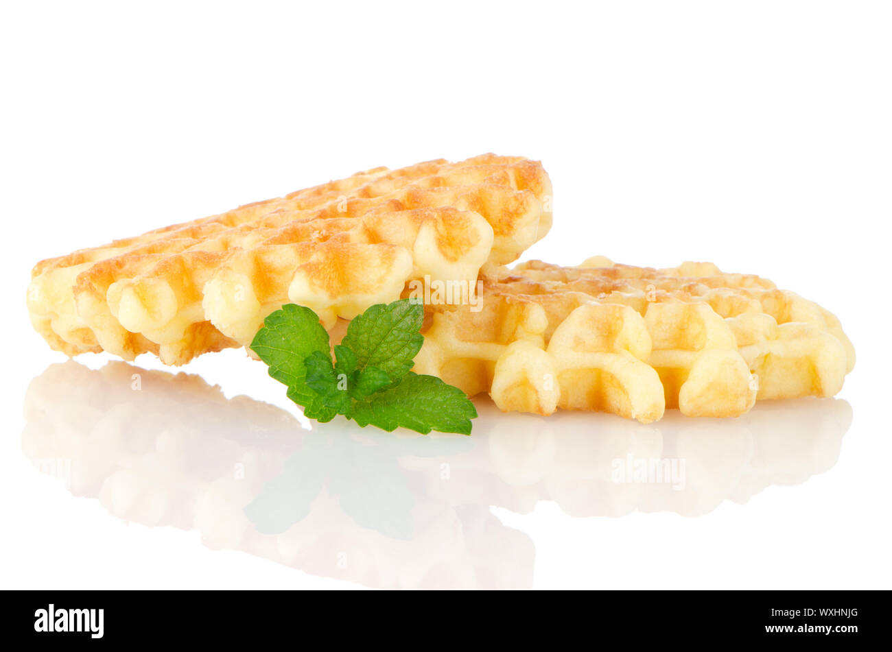 Pile of sweet waffles with green mint leaves isolated on white ...