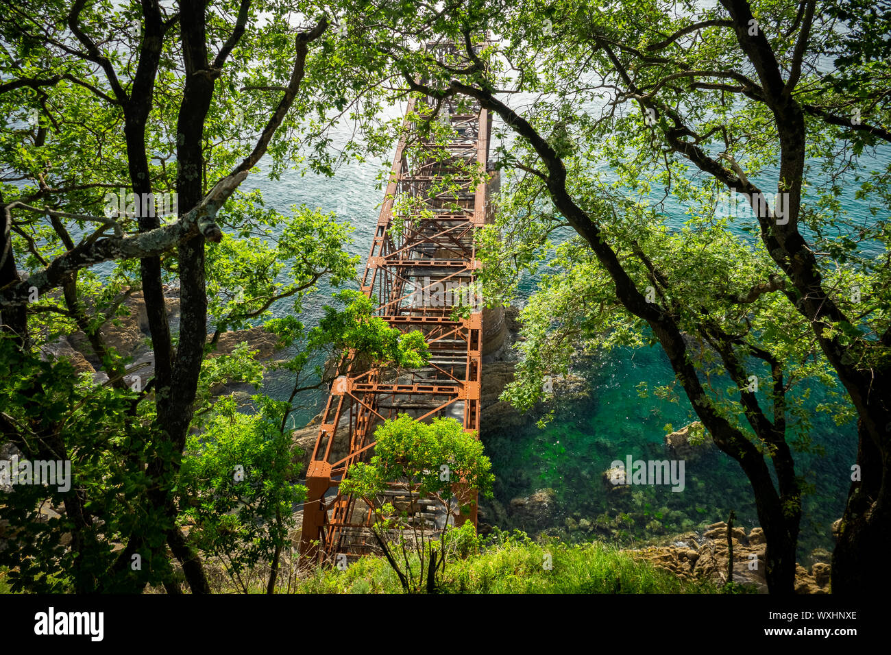 Old abandoned rusty iron loading bay in the sea shore Stock Photo - Alamy