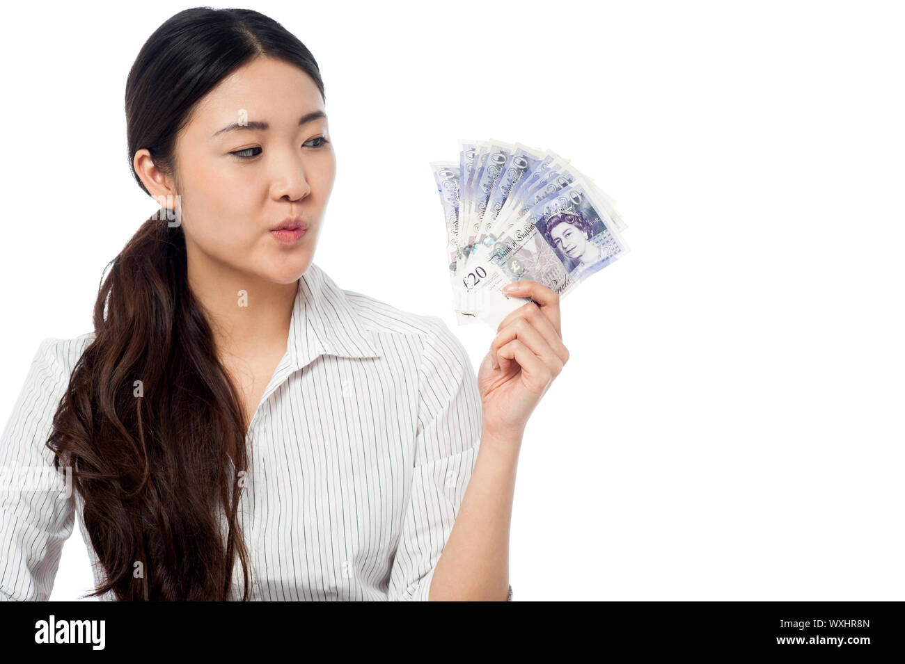 Asian girl with a fan of currency notes on white background Stock Photo ...