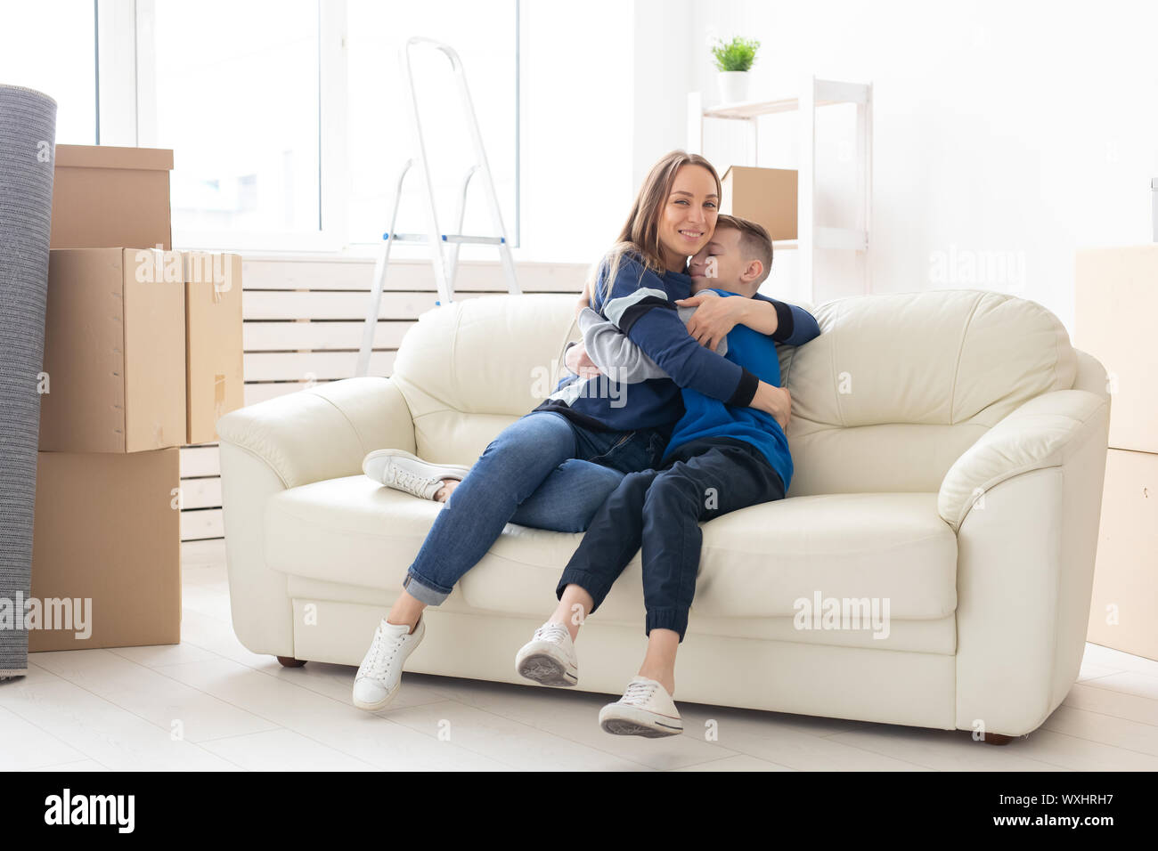 Cute single mom and little boy son relaxing after the move. The concept ...