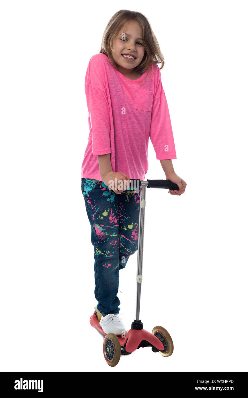 Pretty caucasian girl riding cycle scooter Stock Photo - Alamy
