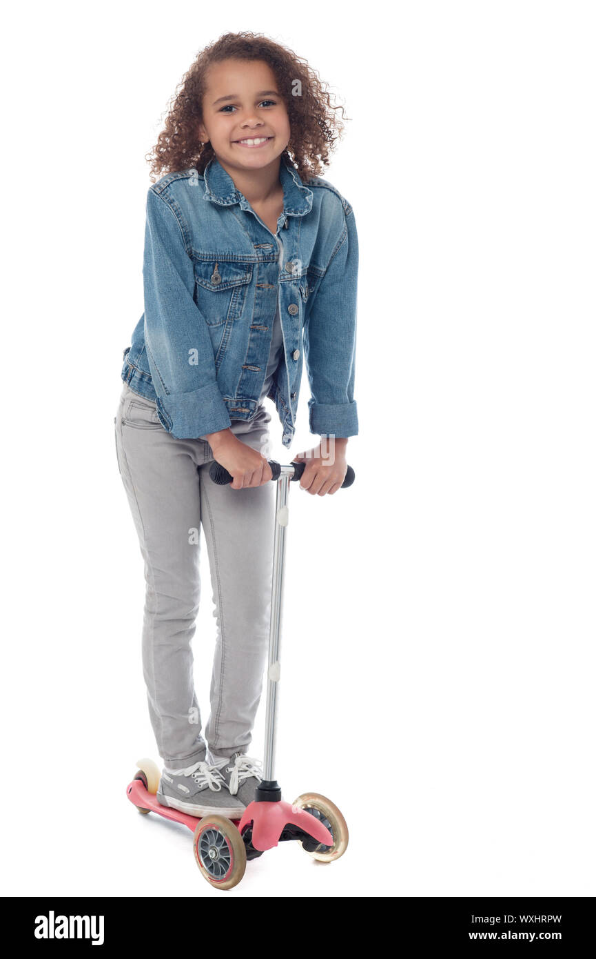 Cute African kid riding cycle scooter Stock Photo - Alamy