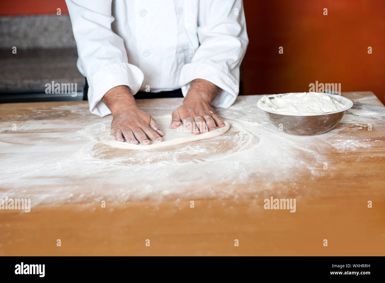 Baker preparing pizza base Stock Photo - Alamy
