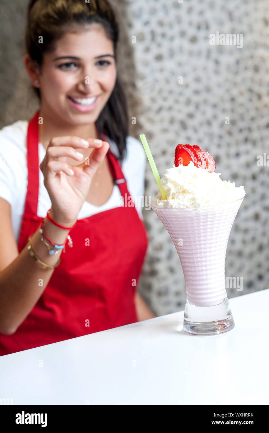 Pretty female chef serving fresh strawberry shake Stock Photo - Alamy