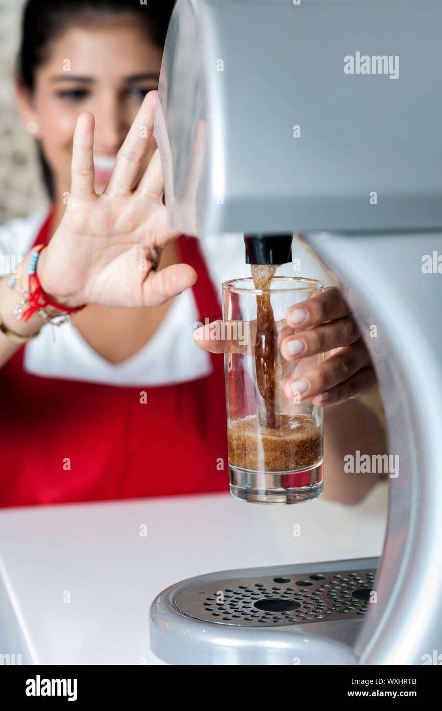 Woman operating machine to extract chocolate shake Stock Photo - Alamy