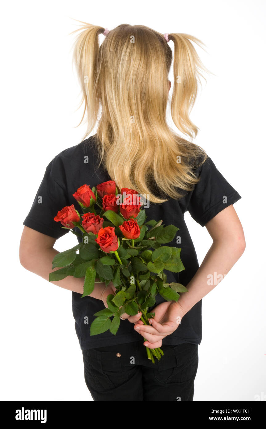 Red roses hiding behind her back for mother Stock Photo - Alamy
