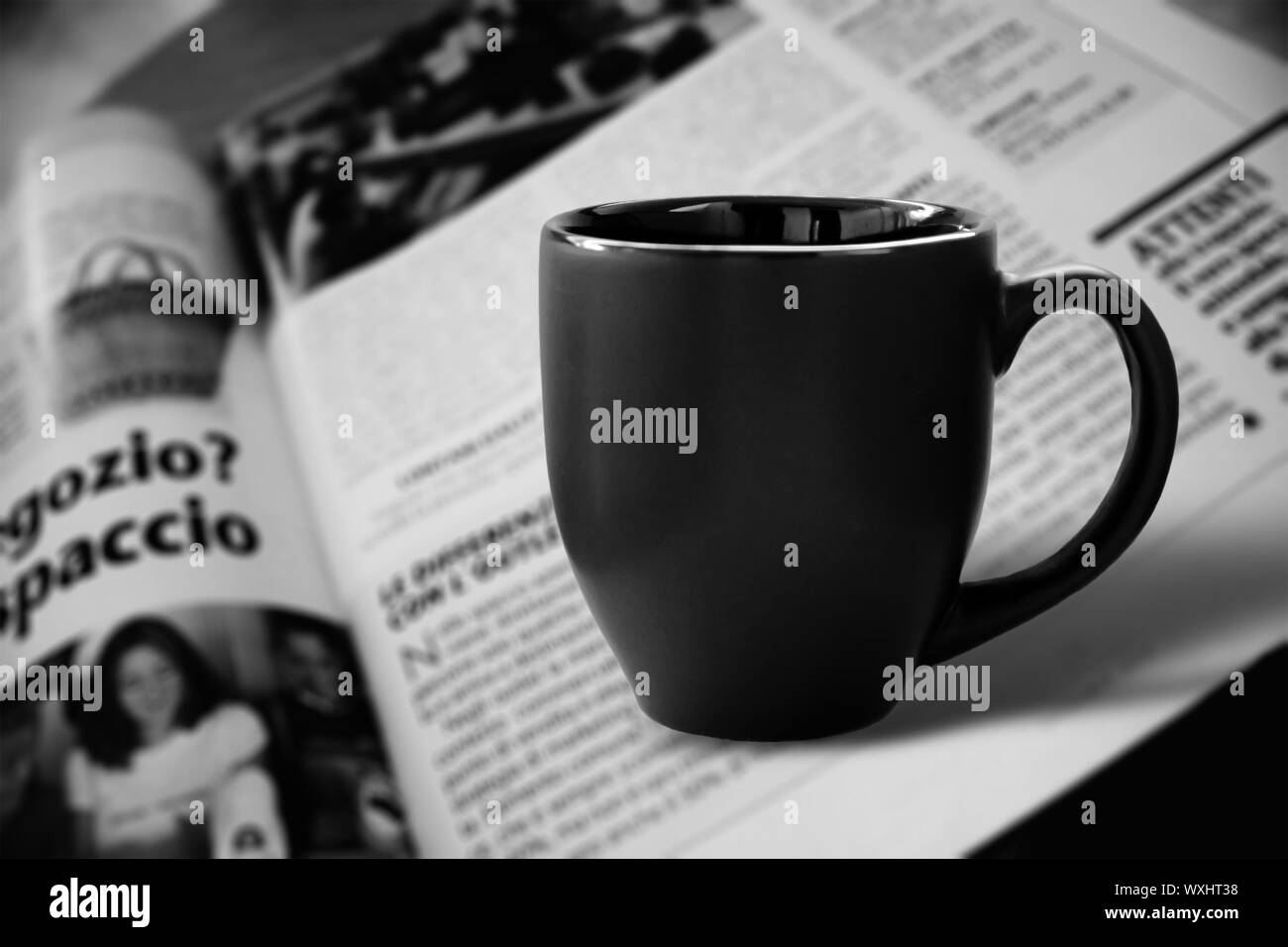 Black cup and newspaper Stock Photo - Alamy