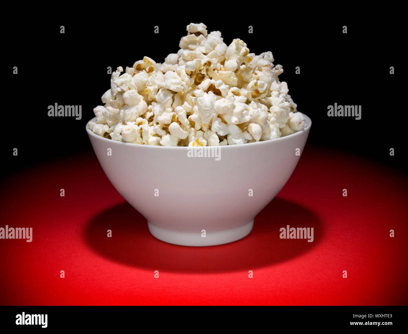 A bowl full of popcorn under the spotlight Stock Photo - Alamy
