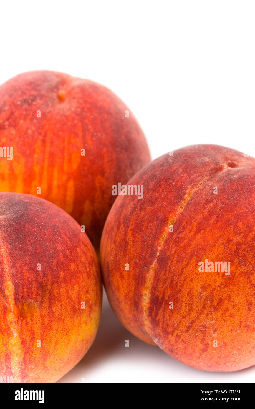 three peaches closeup on white background Stock Photo - Alamy