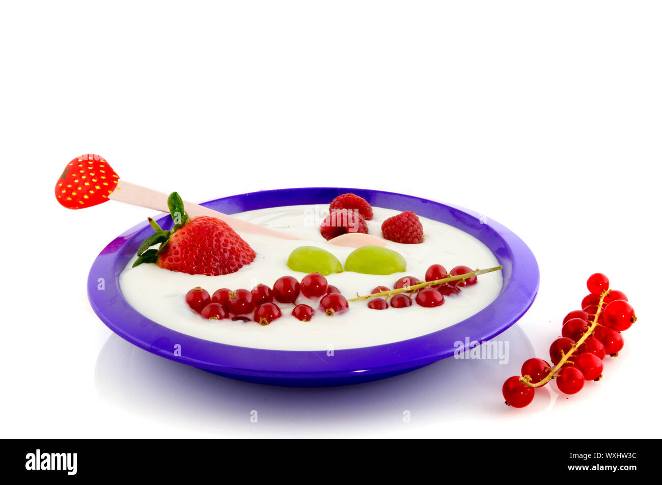 Purple plate of yogurt with juice fresh fruit Stock Photo - Alamy