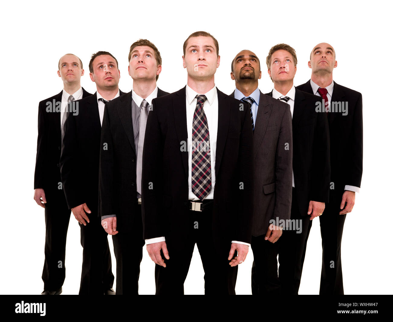 Confident team looking up isolated on white background Stock Photo - Alamy