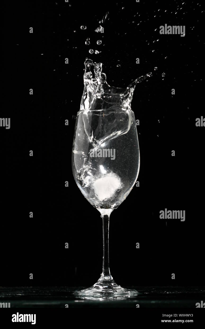 alcohol splash on black background Stock Photo - Alamy