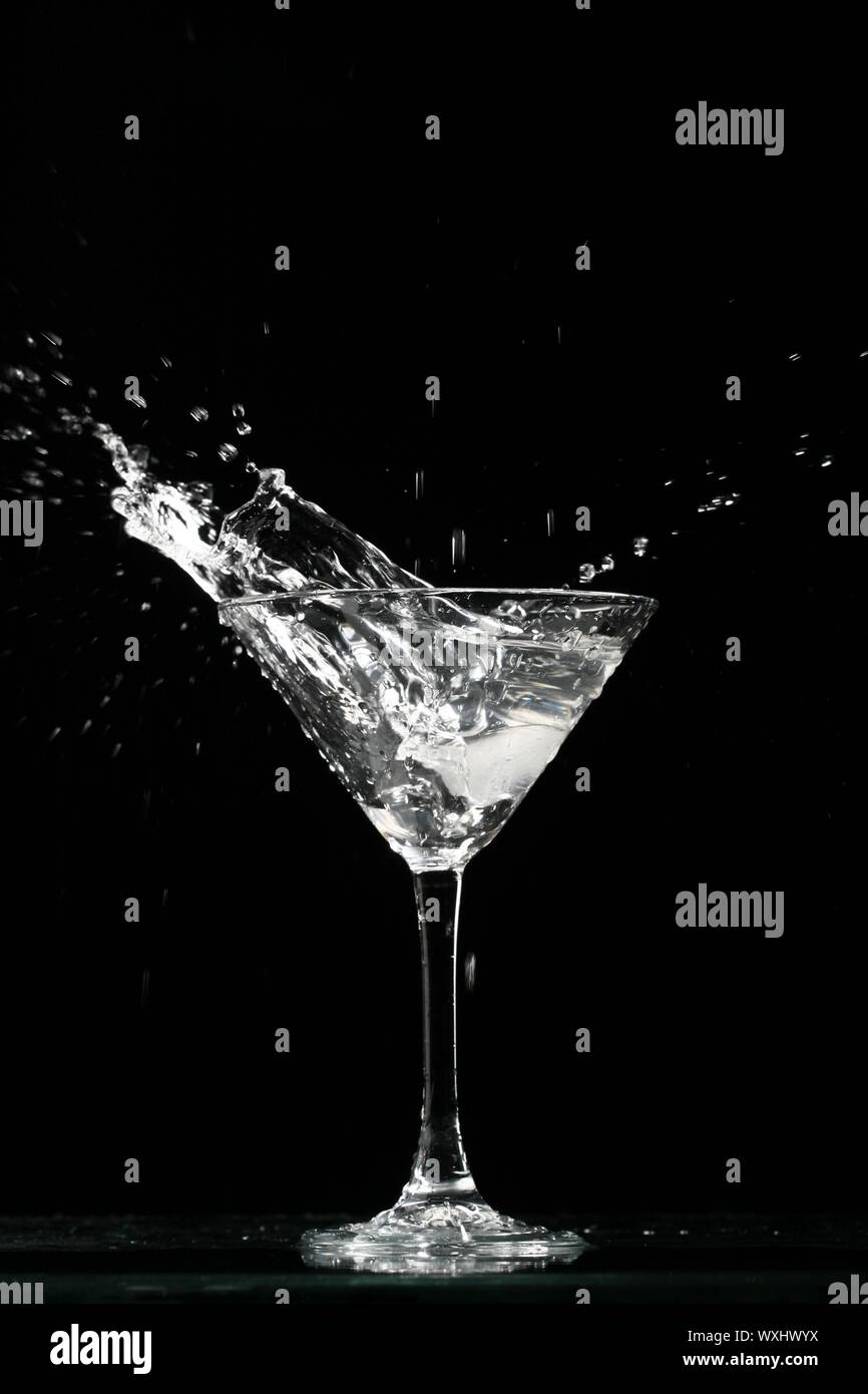 alcohol splash on black background Stock Photo - Alamy