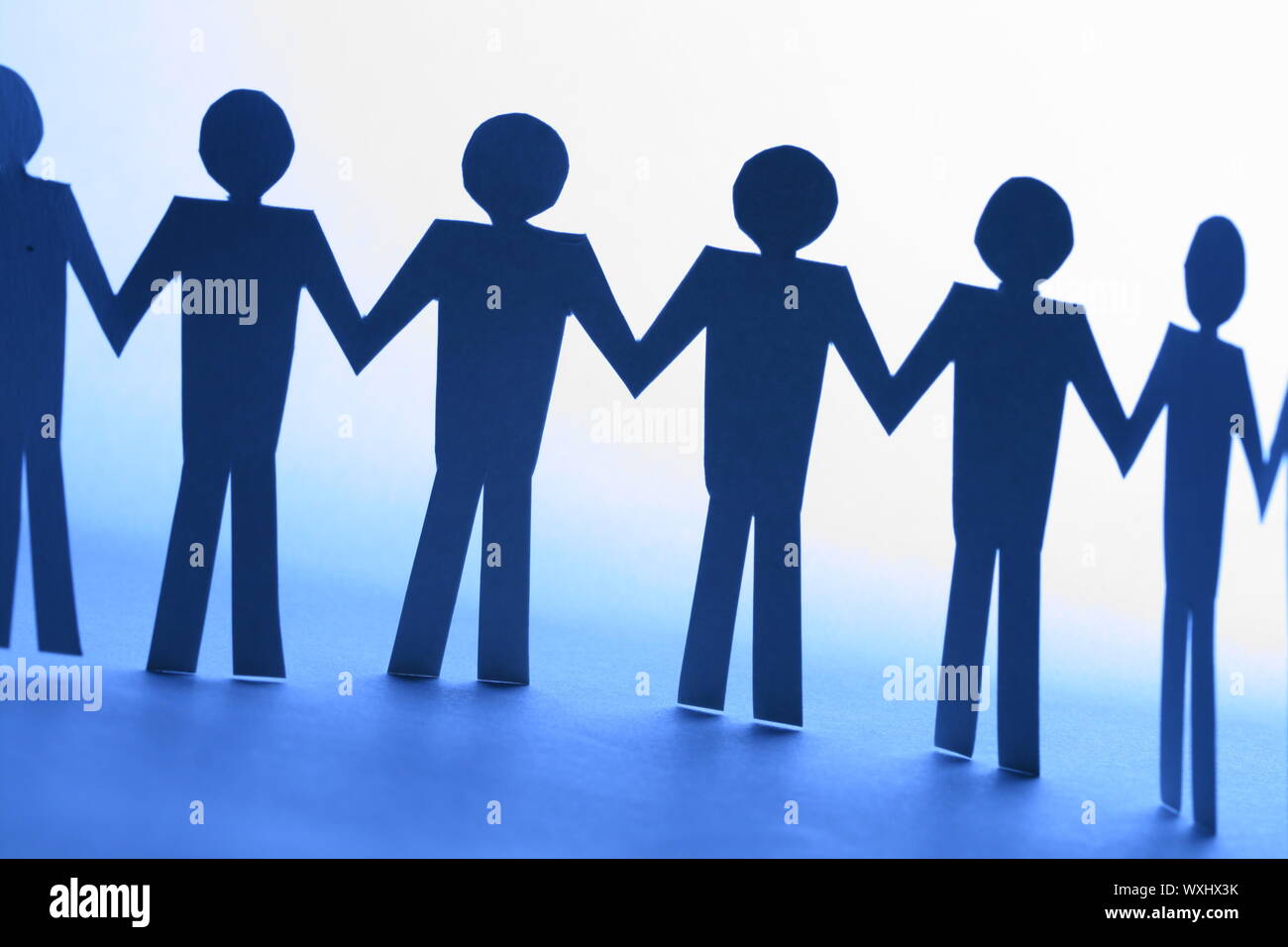 paper team linked together partnership concept Stock Photo - Alamy