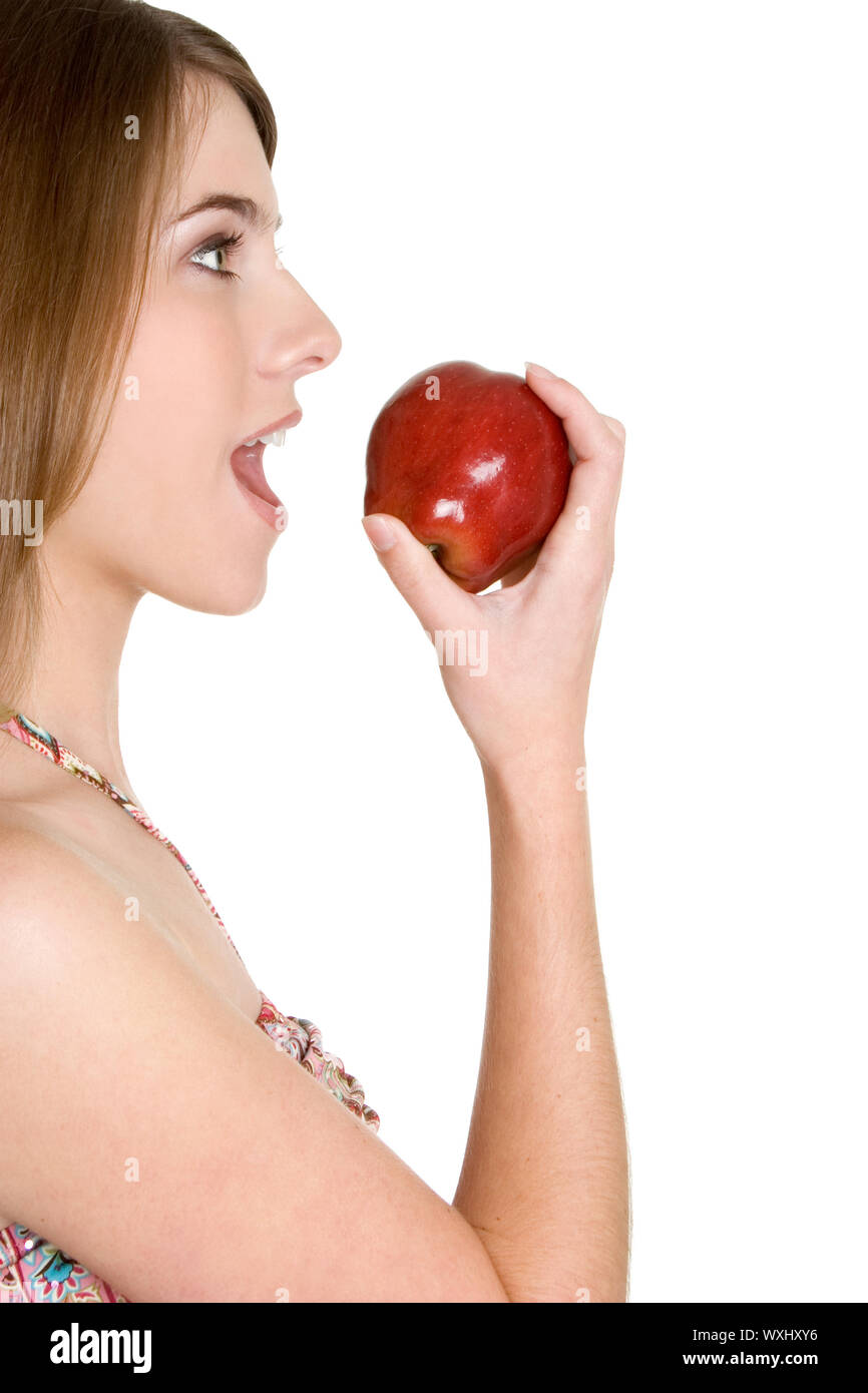 Beautiful girl eating red apple Stock Photo - Alamy