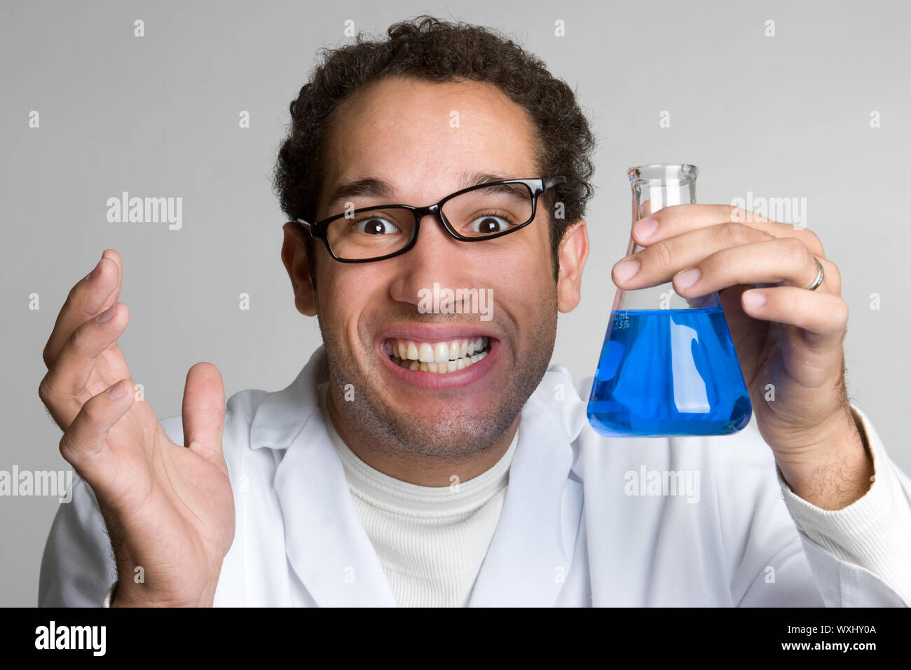 Mad scientist holding blue liquid vial Stock Photo - Alamy