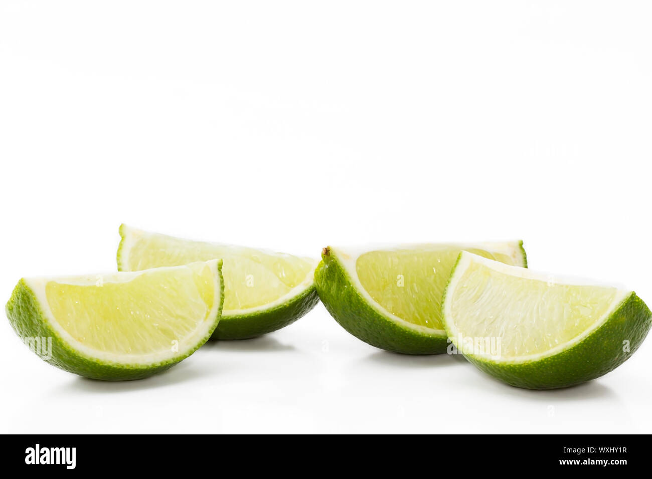 four lemon slices on white background Stock Photo - Alamy