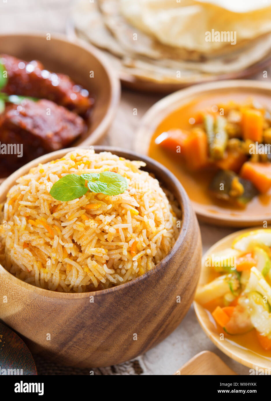 Indian meal biryani rice, chicken curry, acar vegetable, roti chapatti ...