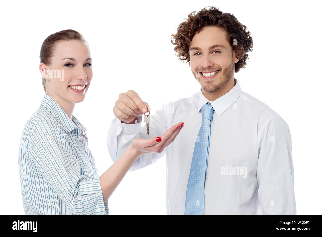Corporate guy handing over the key to assistant Stock Photo - Alamy