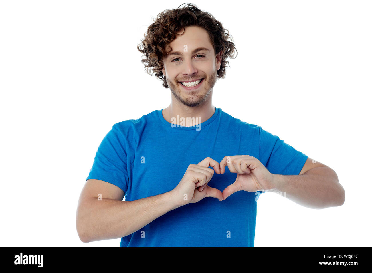 Handsome guy making heart shape with his hands Stock Photo - Alamy