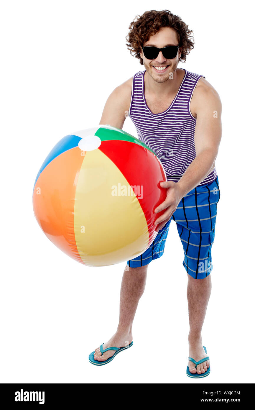 Young handsome guy playing with a beach ball Stock Photo - Alamy
