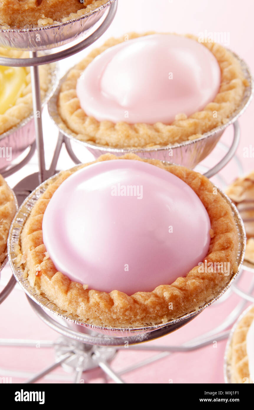 engish style pink tarts on a cake stand Stock Photo - Alamy