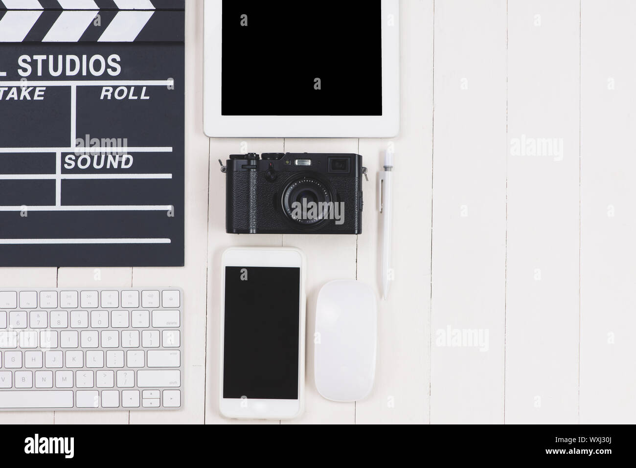 top view of film clapper and gadgets on wooden desk Stock Photo - Alamy