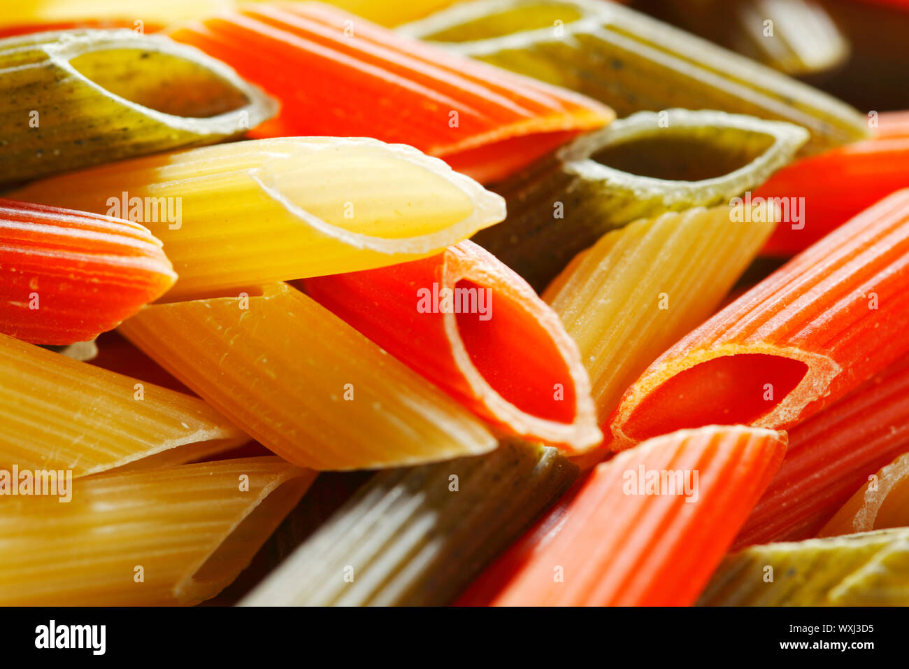 Colored dry italian pasta background Stock Photo - Alamy
