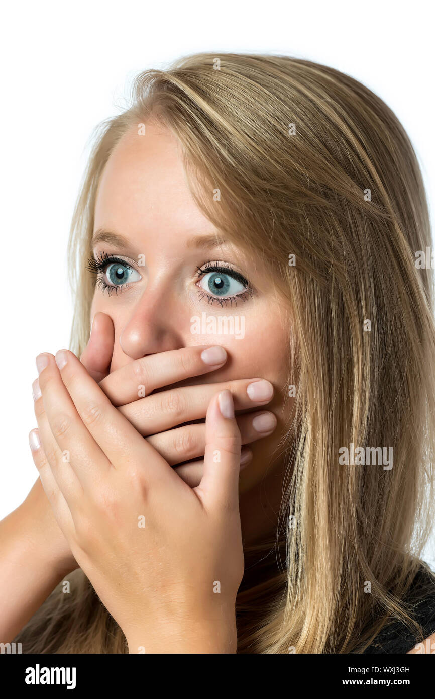 Portrait of shocked young girl who is afraid and keeps up with eyes ...