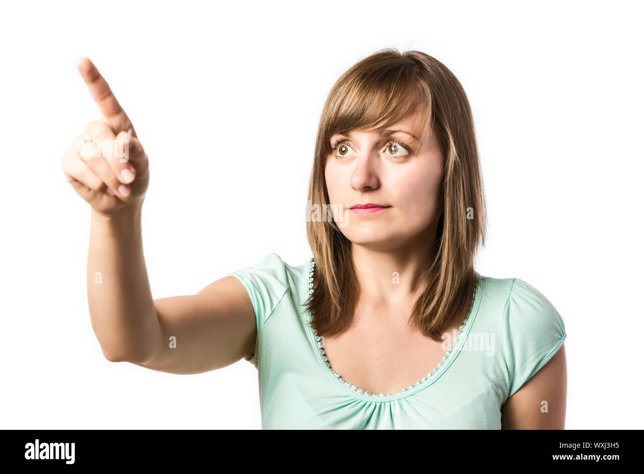 Young girl shows a finger at something, isolated on white background ...