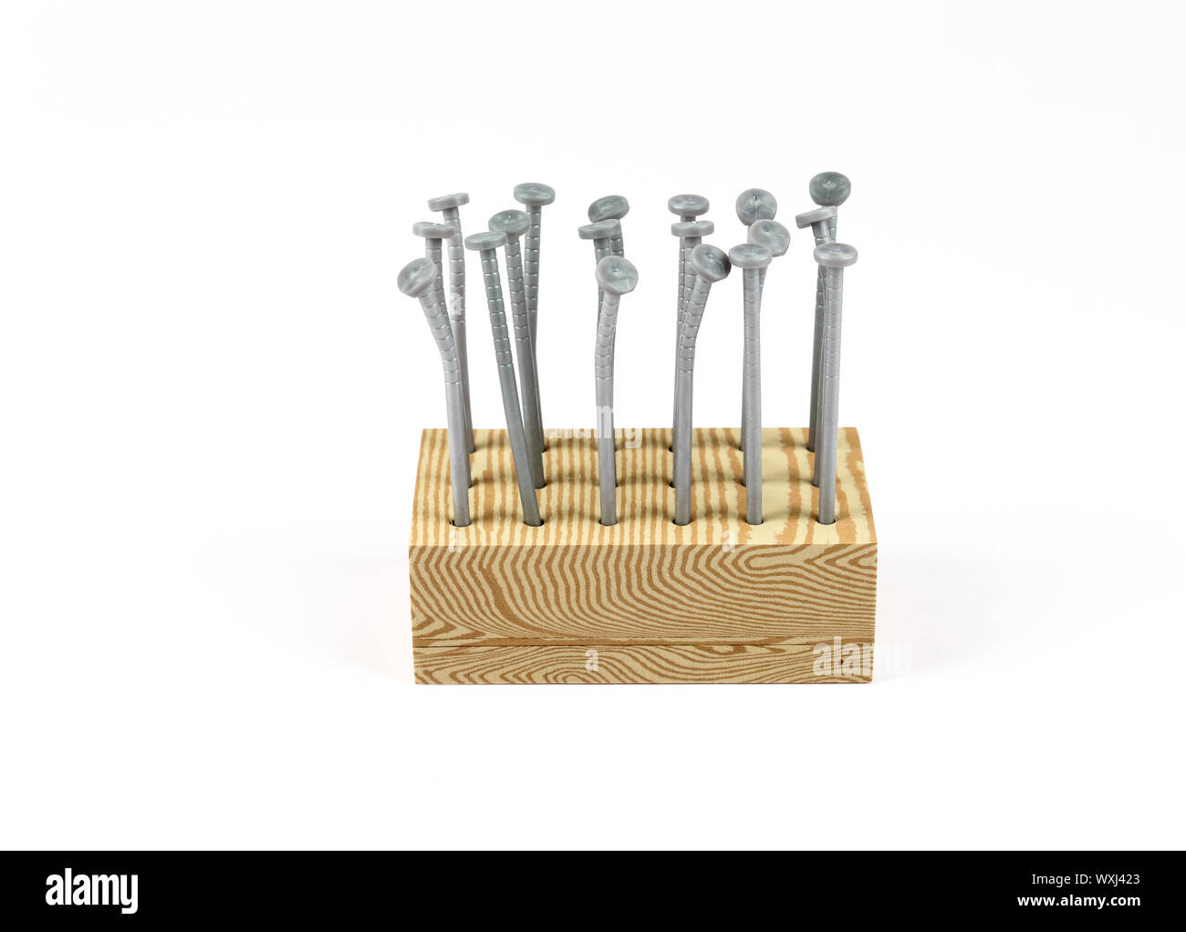 Bunch of nails on a wood surface Stock Photo - Alamy