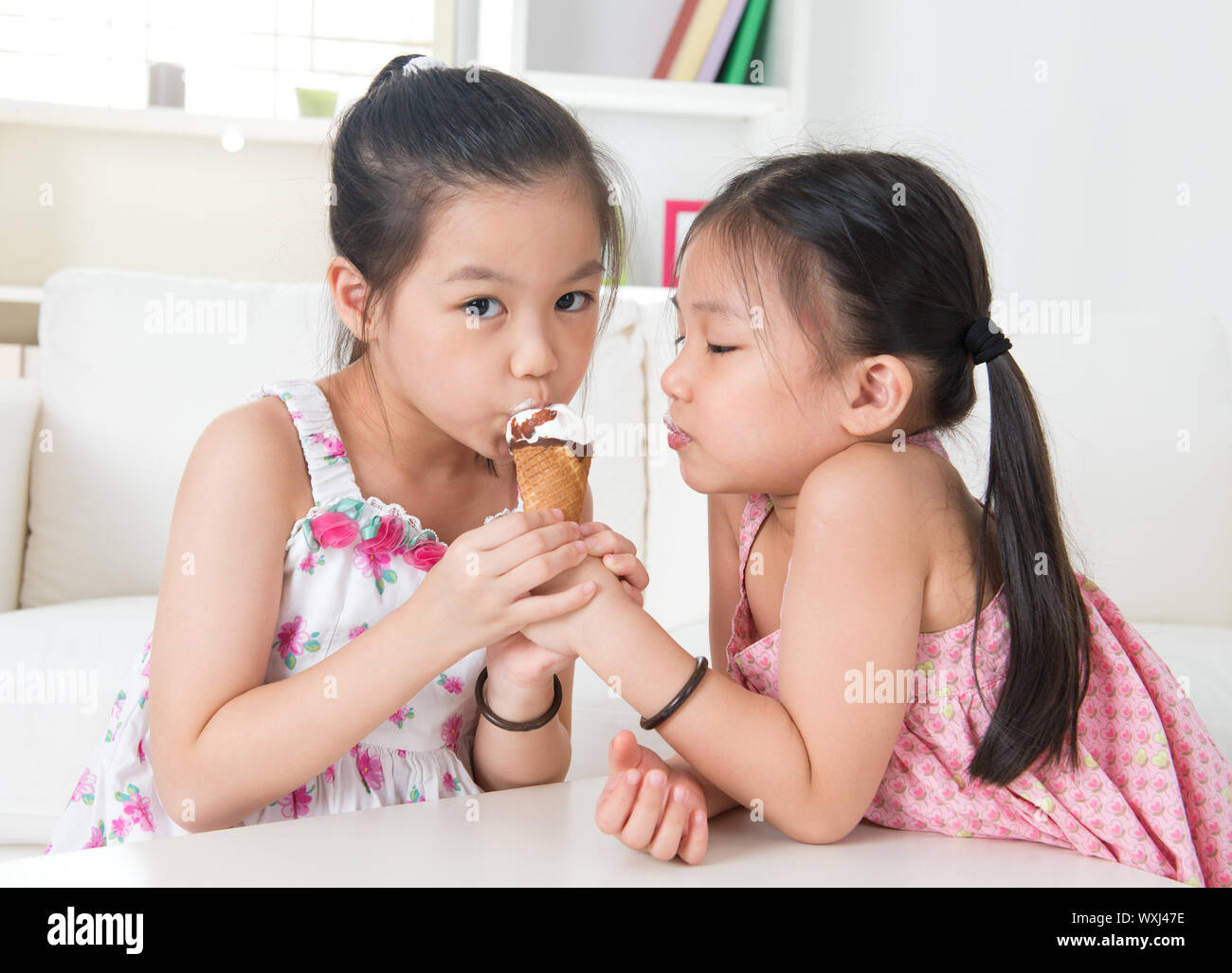 Two children sharing ice cream hi-res stock photography and images - Alamy