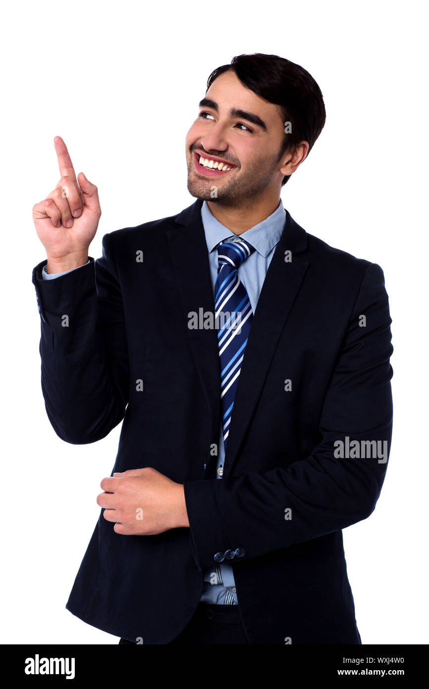 Smiling corporate guy pointing at something Stock Photo - Alamy