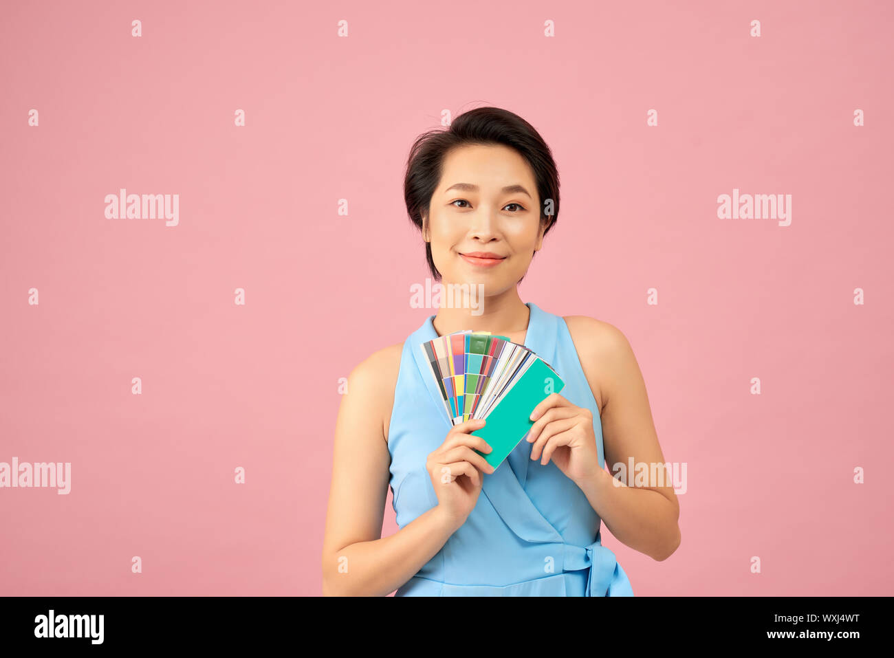 Pretty female designer showing color palette Stock Photo - Alamy