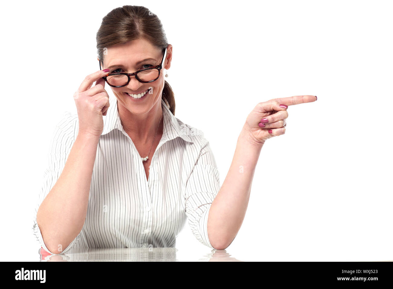 Professional woman pointing at something Stock Photo - Alamy