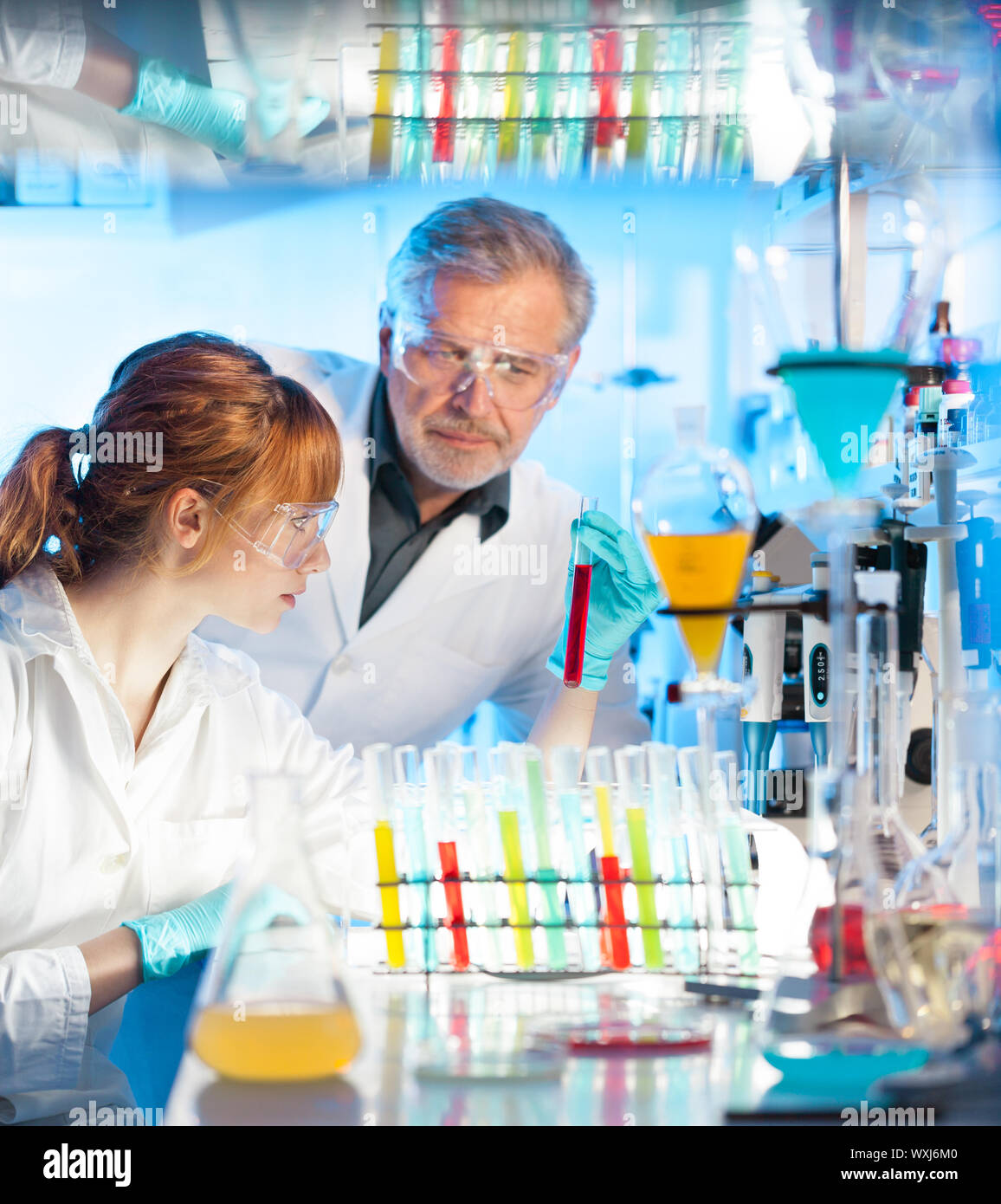 Attractive young female scientist and her senior male supervisor ...